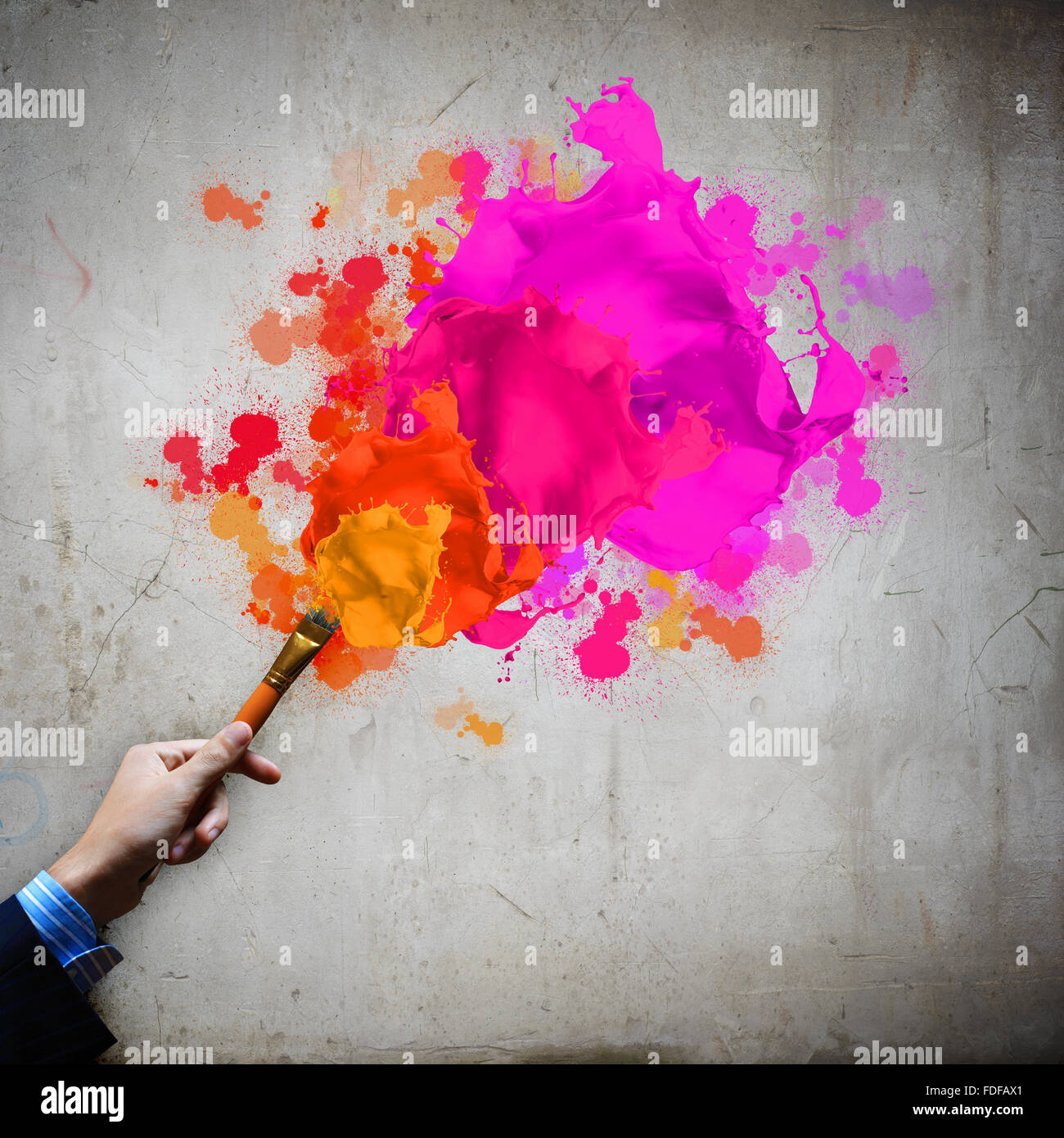 Close-up of human hand holding paint brush making colorful paint ...