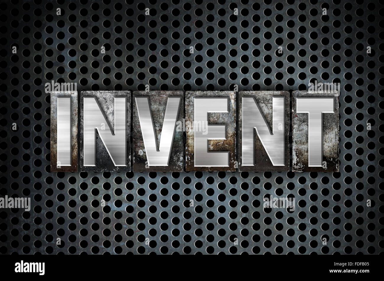 The word "Invent" written in vintage metal letterpress type on a black ...