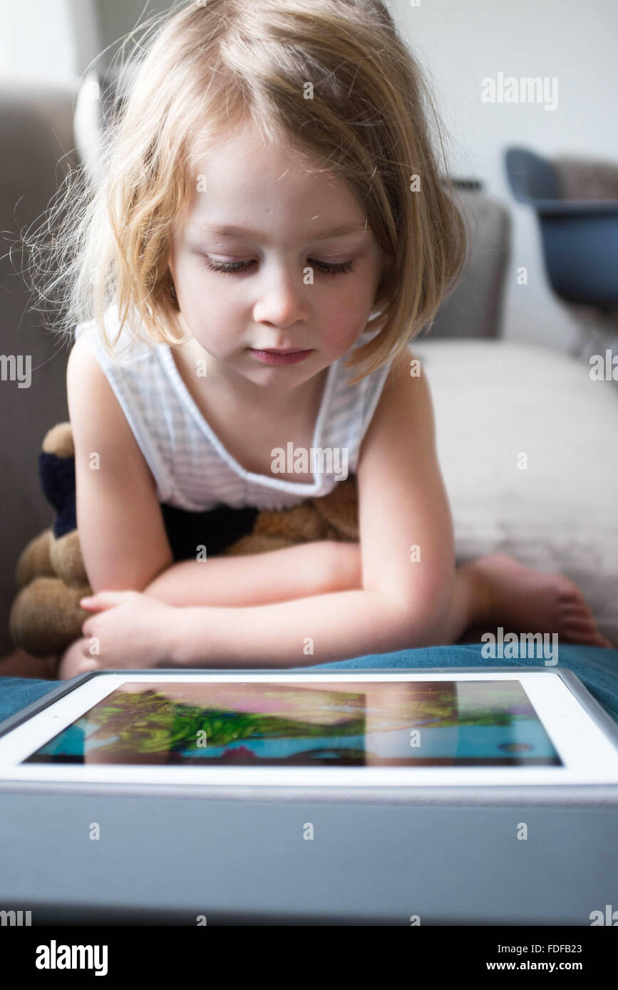 Girl ipad sitting on sofa hi-res stock photography and images - Alamy