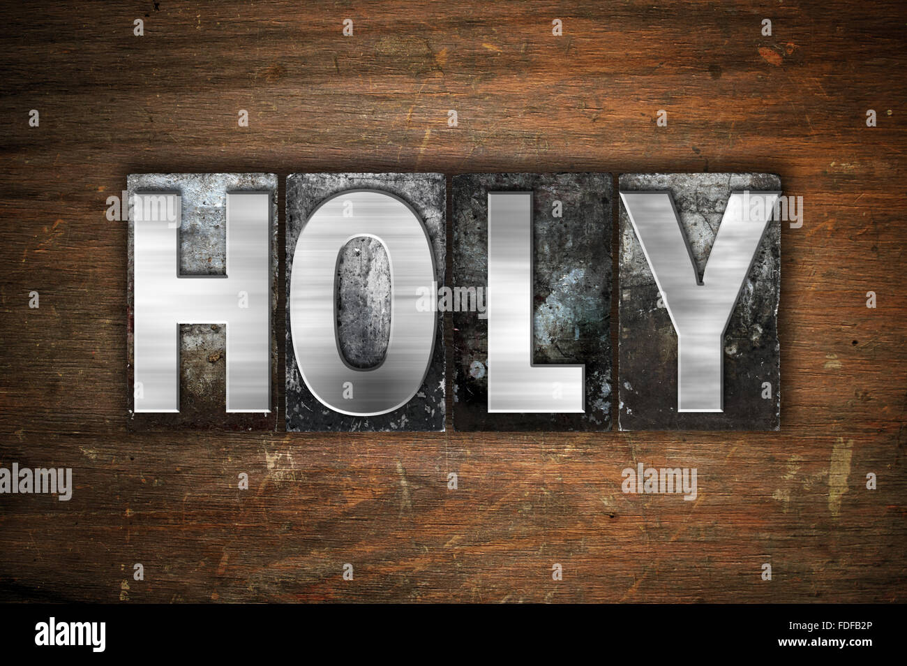 The word "Holy" written in vintage metal letterpress type on an aged ...