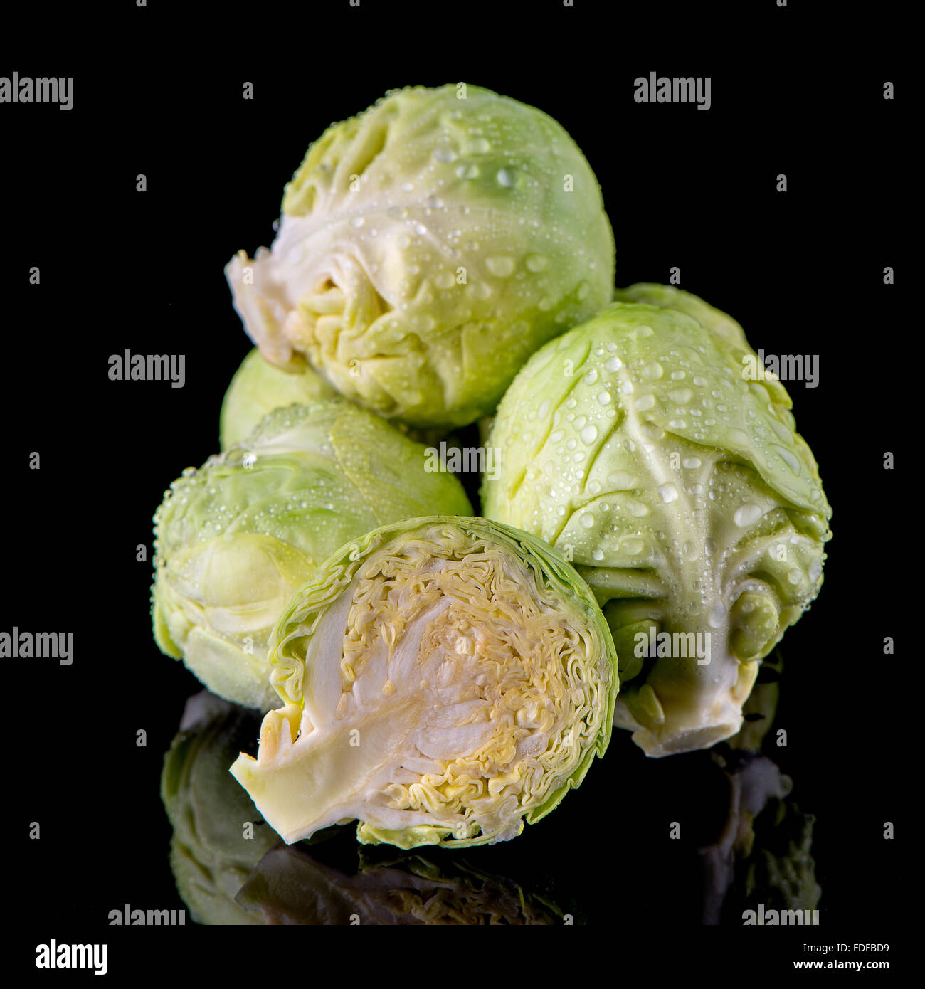 Fresh brussels sprouts isolated on black background Stock Photo - Alamy