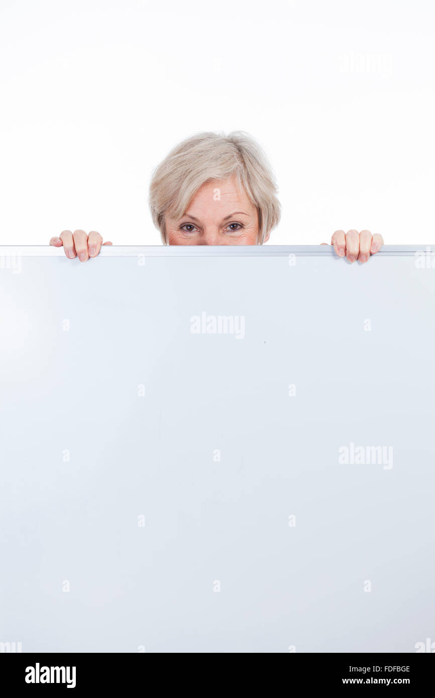 beautiful happy smiling older senior women holding sign with text space ...
