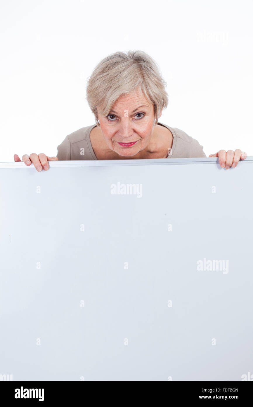 beautiful happy smiling older senior women holding sign with text space ...