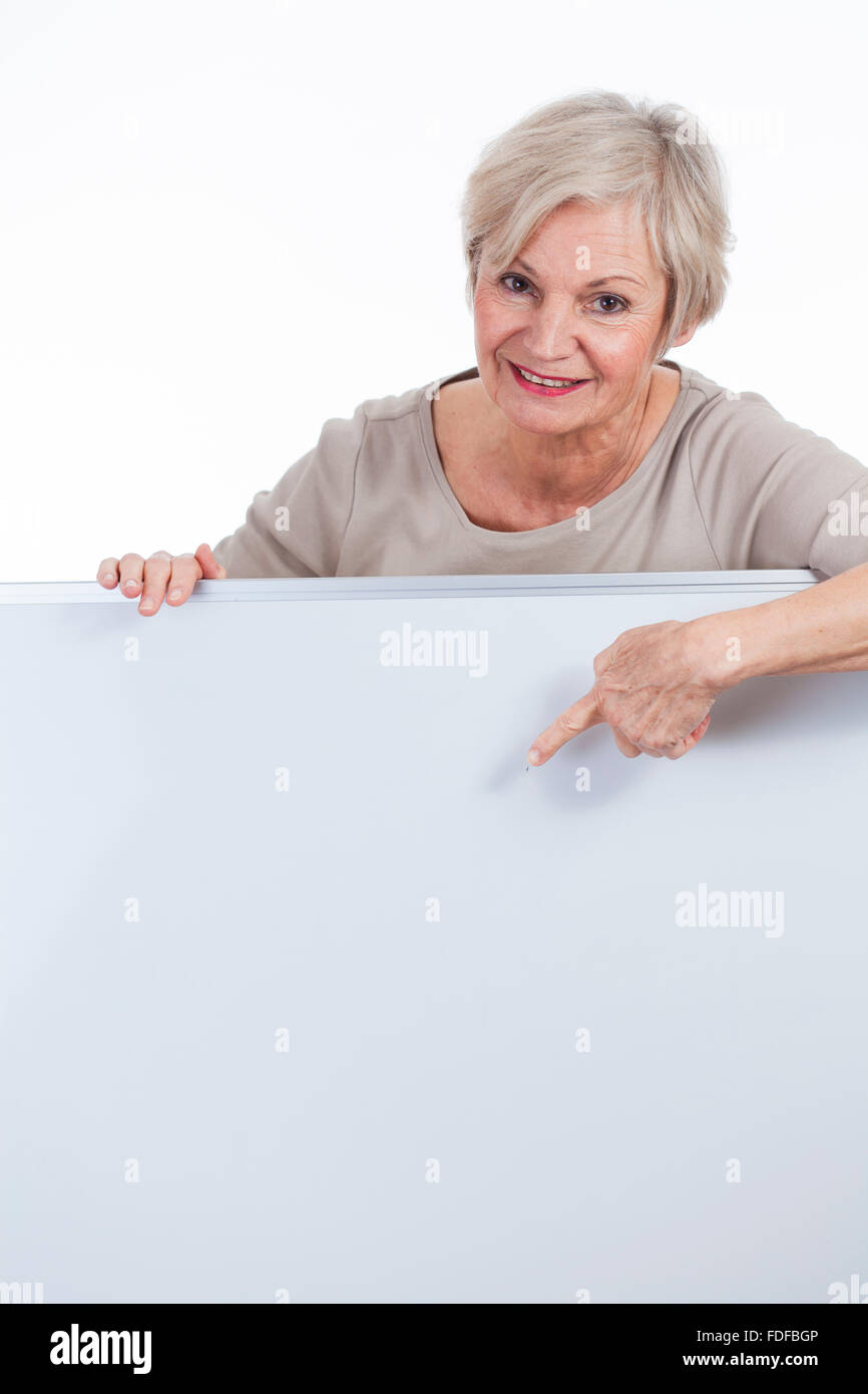 beautiful happy smiling older senior women holding sign with text space ...
