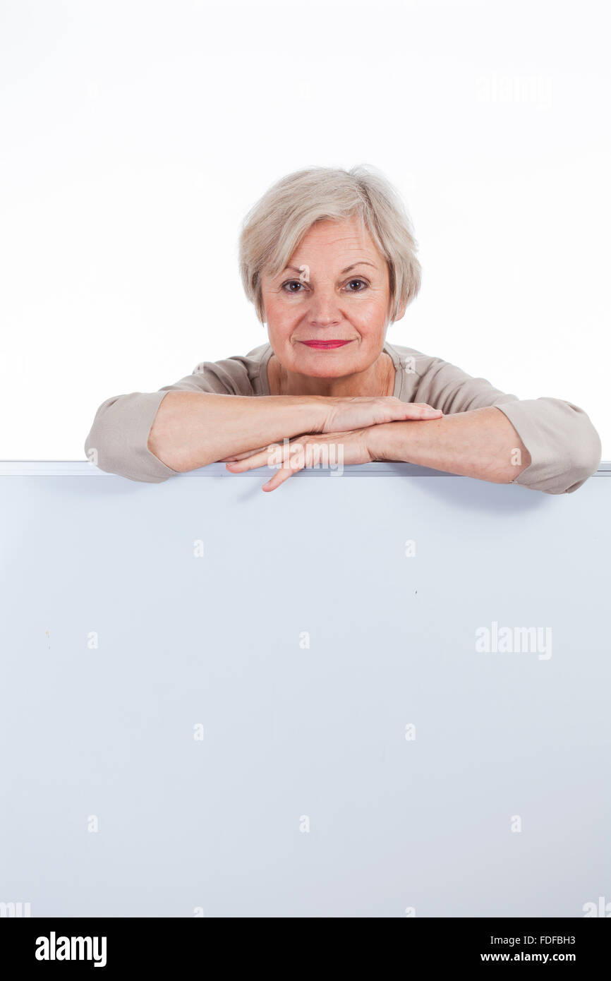 beautiful happy smiling older senior women holding sign with text space ...