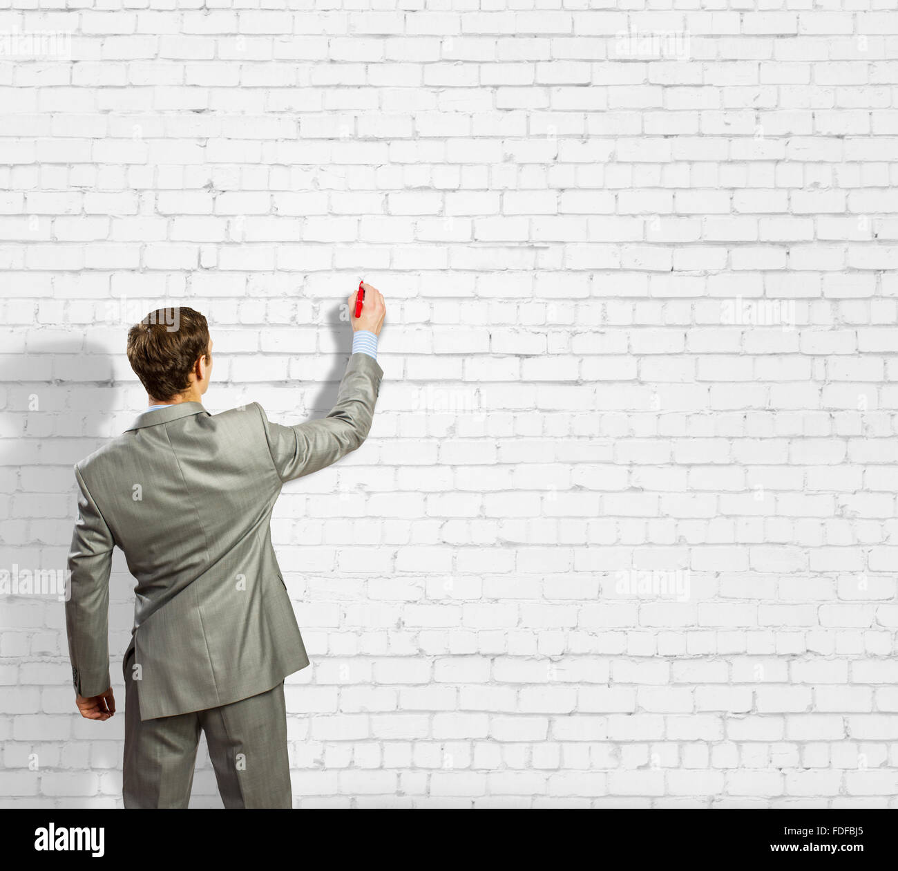 Back view image of businessman drawing on wall Stock Photo - Alamy