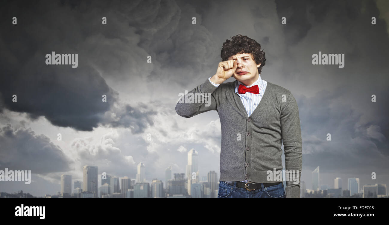 Image of young upset man in red tie crying Stock Photo - Alamy
