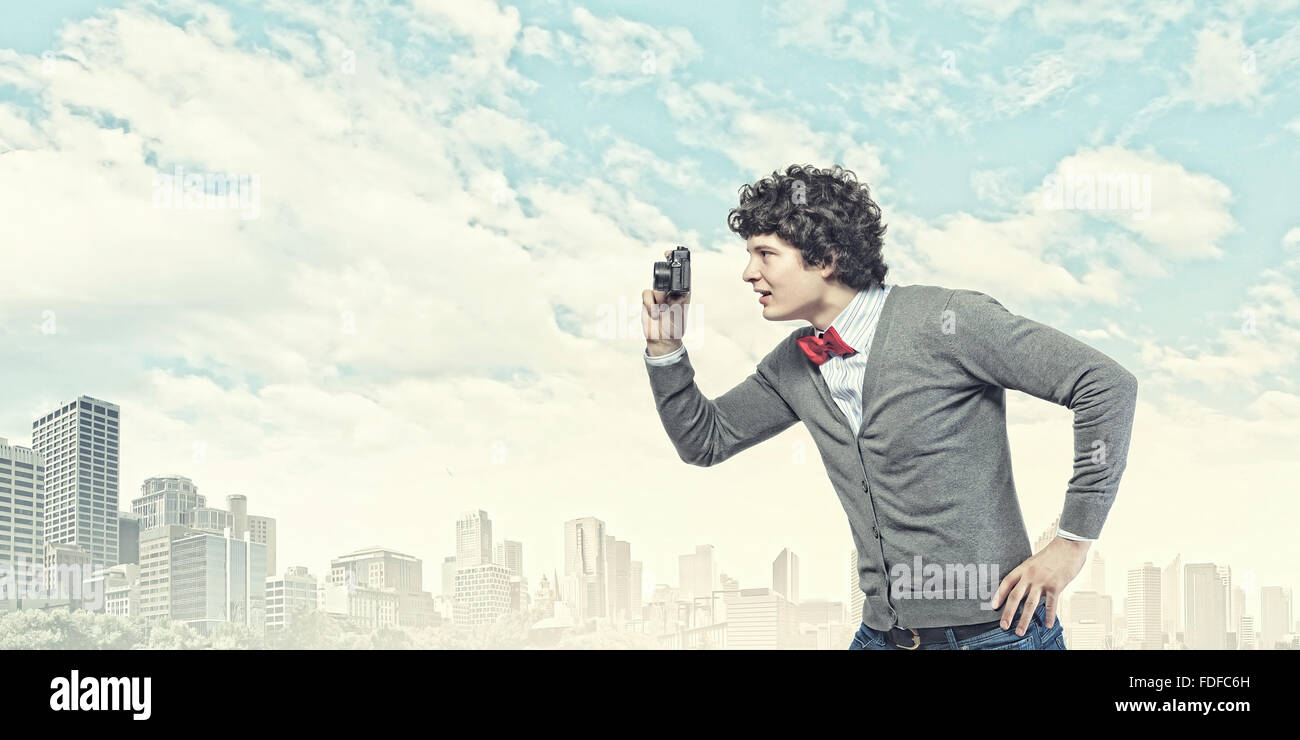 Image of young man in red tie with photo camera taking pictures Stock ...