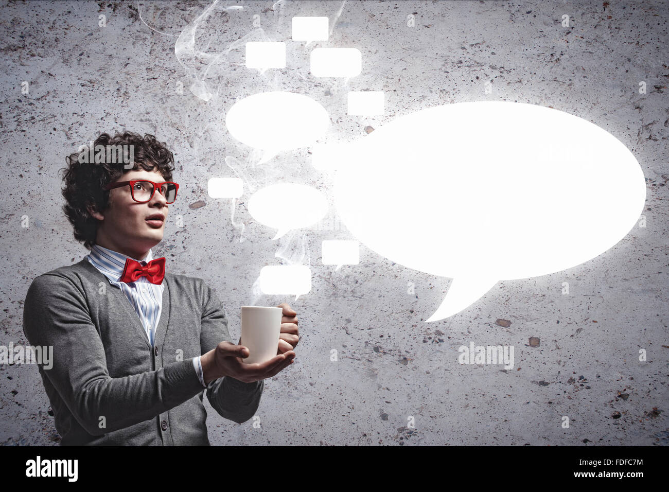 Young man with blank frames against a grey wall Stock Photo - Alamy