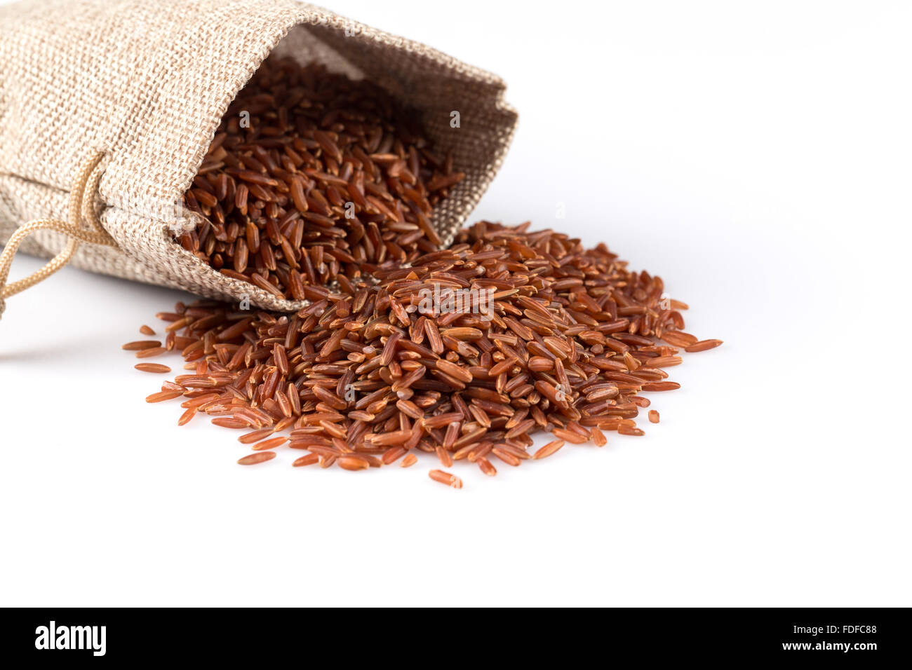 Heap of red rice isolated on white background Stock Photo - Alamy