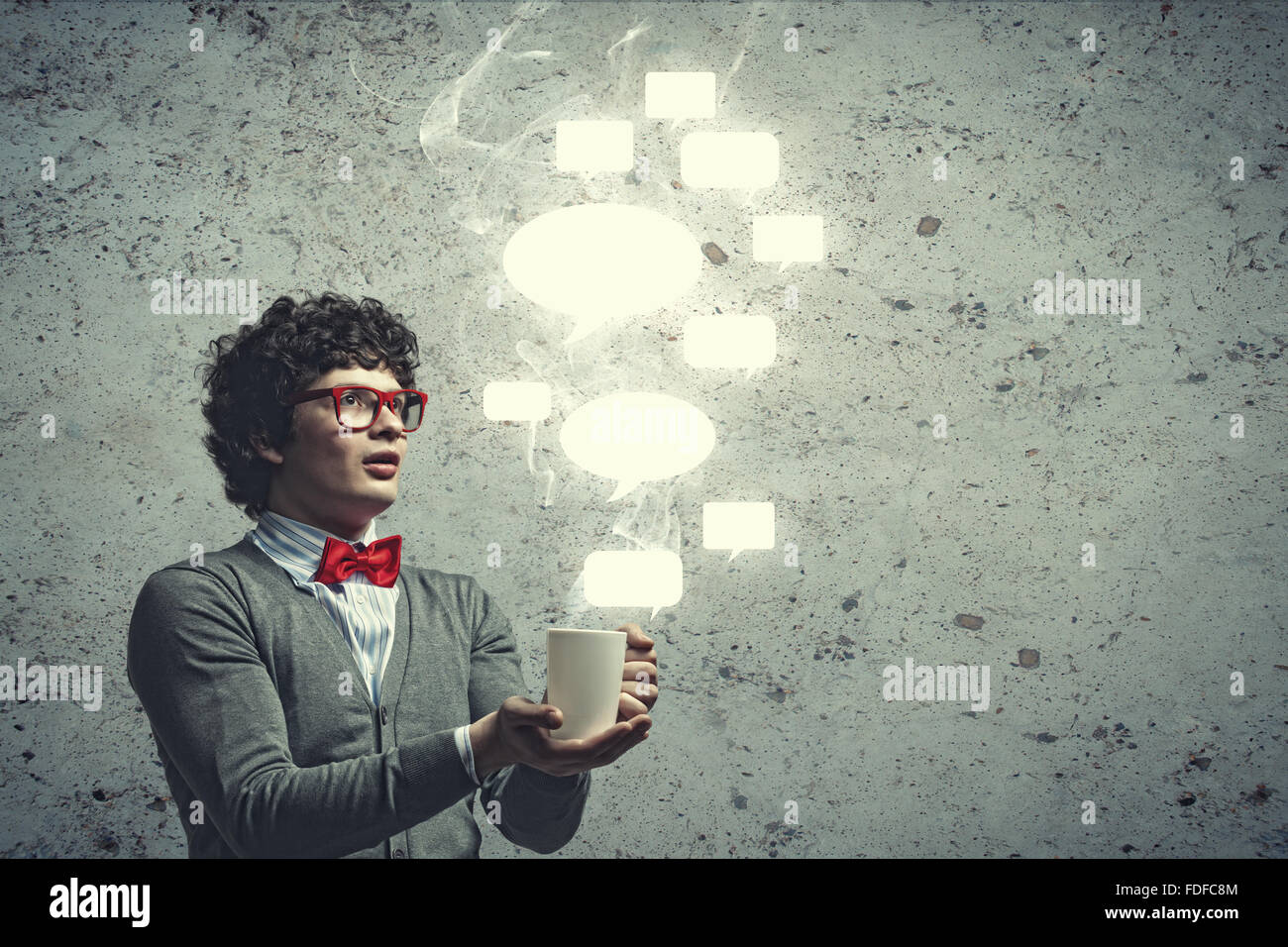 Young man with blank frames against a grey wall Stock Photo - Alamy