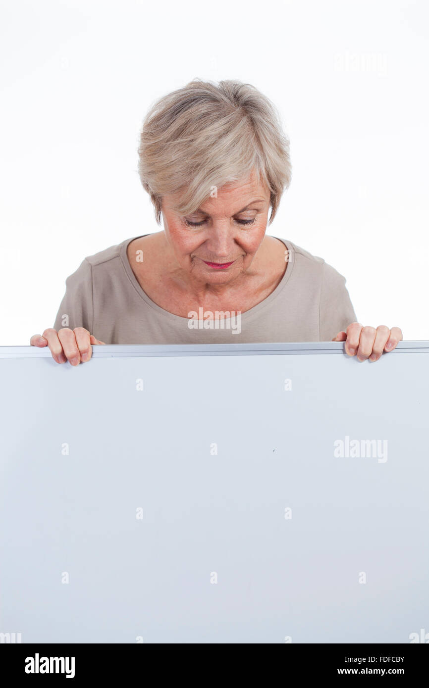beautiful happy smiling older senior women holding sign with text space ...