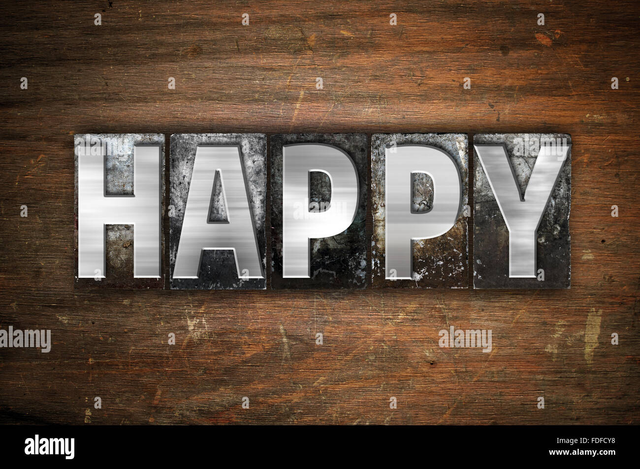 The word "Happy" written in vintage metal letterpress type on an aged ...