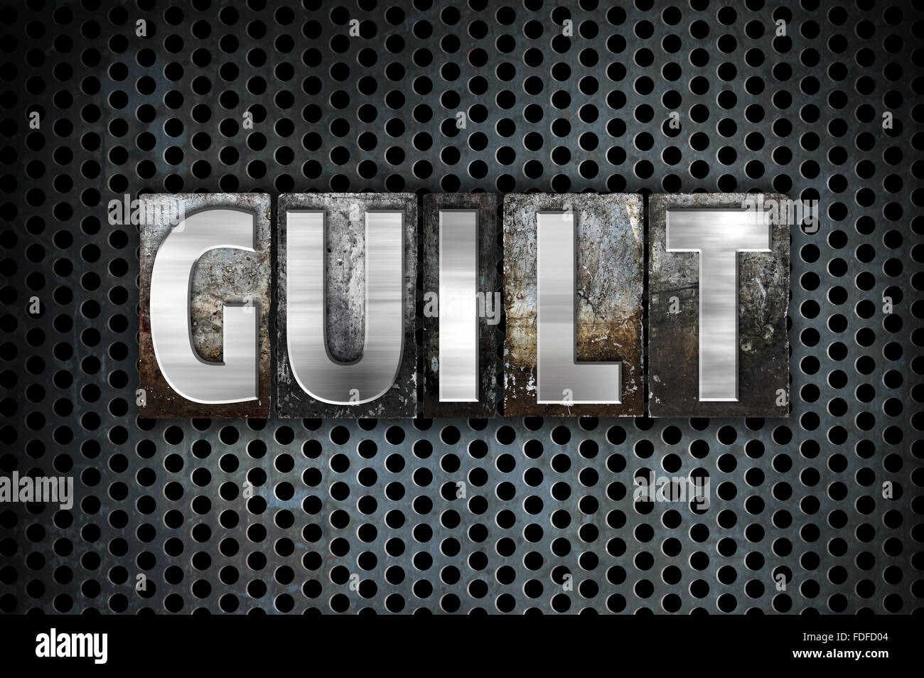 The word "Guilt" written in vintage metal letterpress type on a black ...