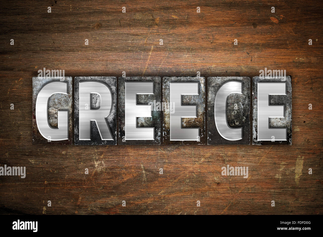 The word "Greece" written in vintage metal letterpress type on an aged ...