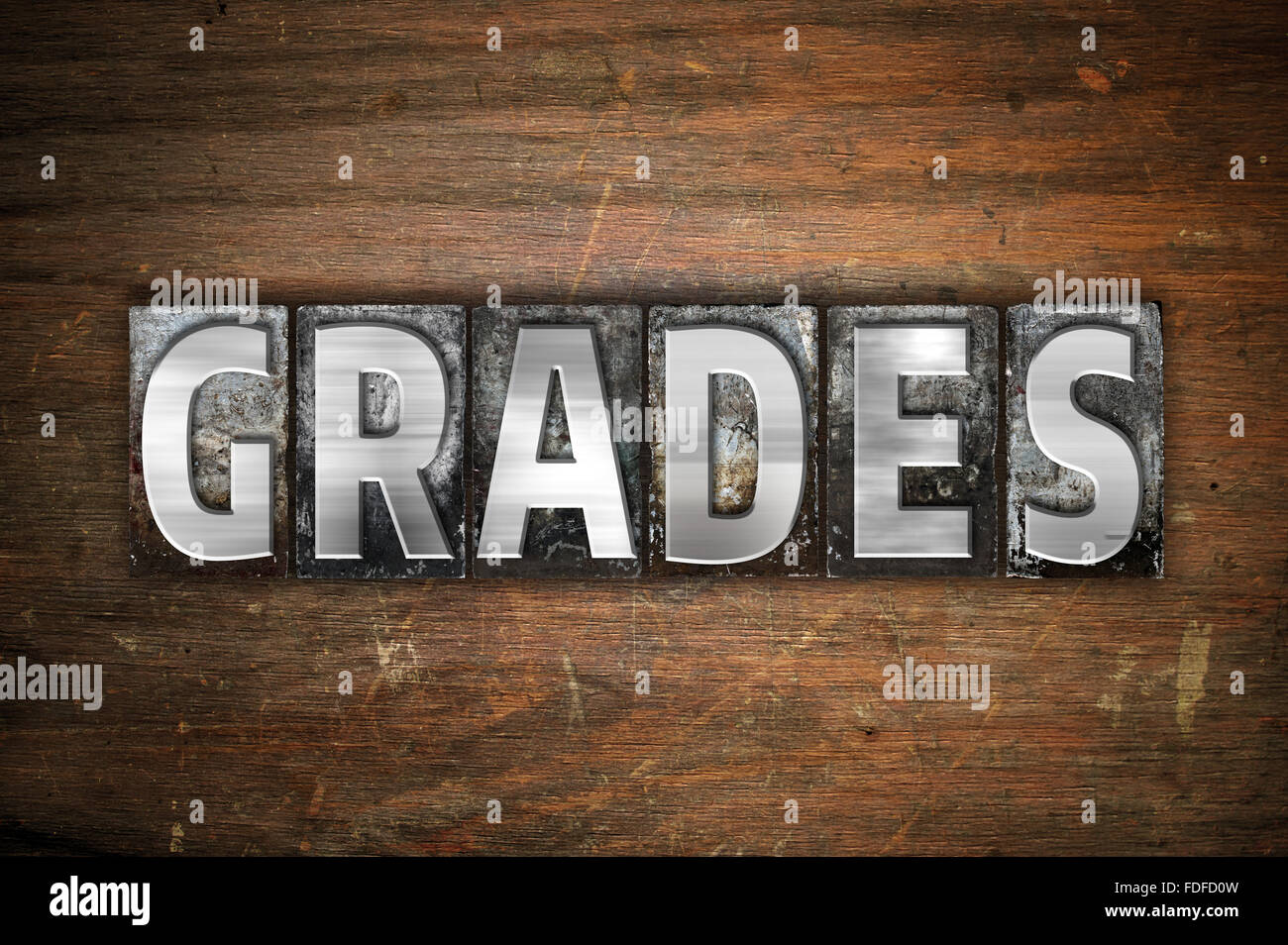 The word "Grades" written in vintage metal letterpress type on an aged ...