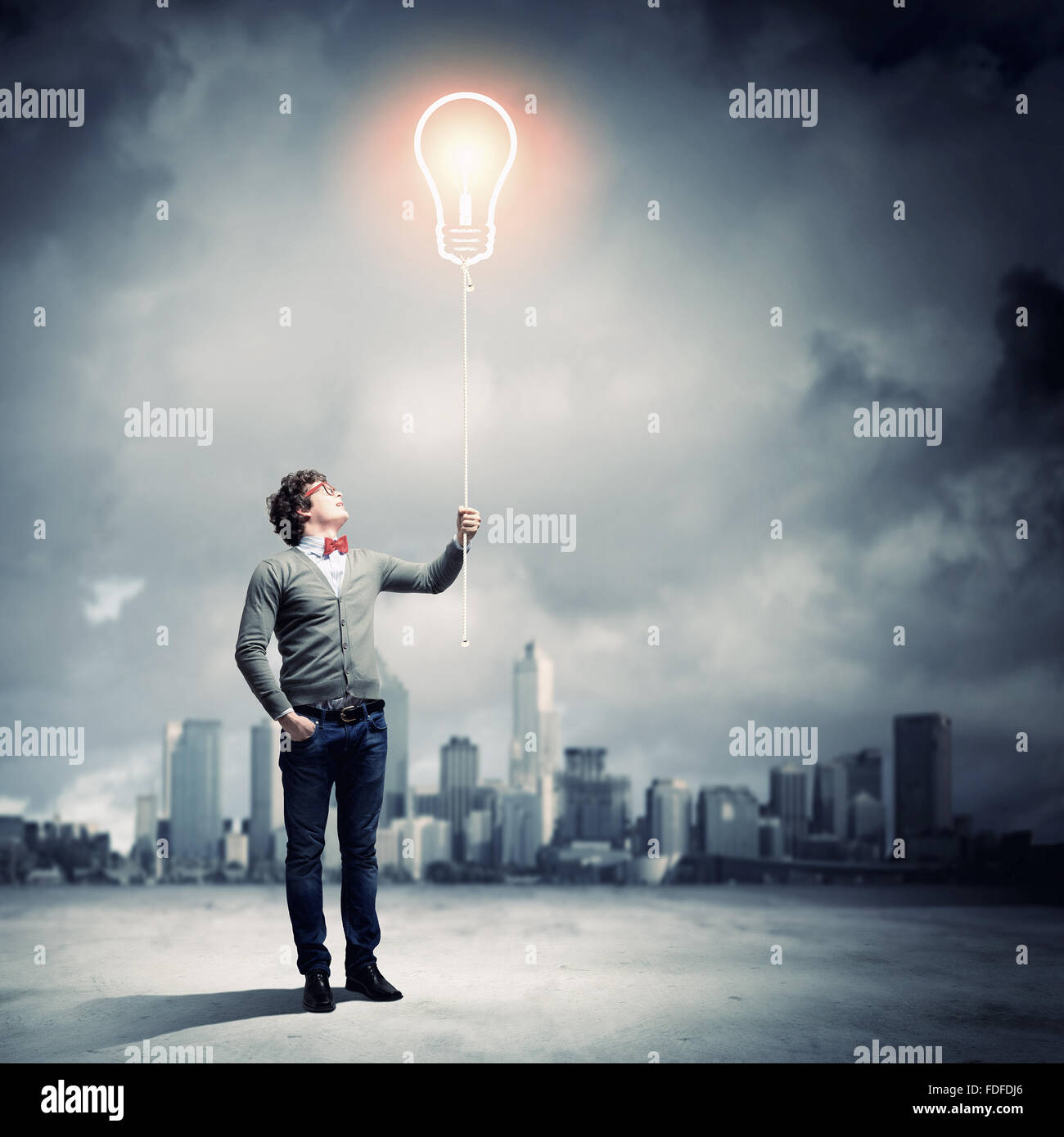 Young man holding a light at his hands against polluted and ruined ...