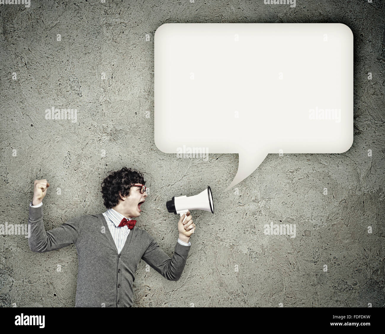 Portrait of young man shouting loudly using megaphone Stock Photo - Alamy