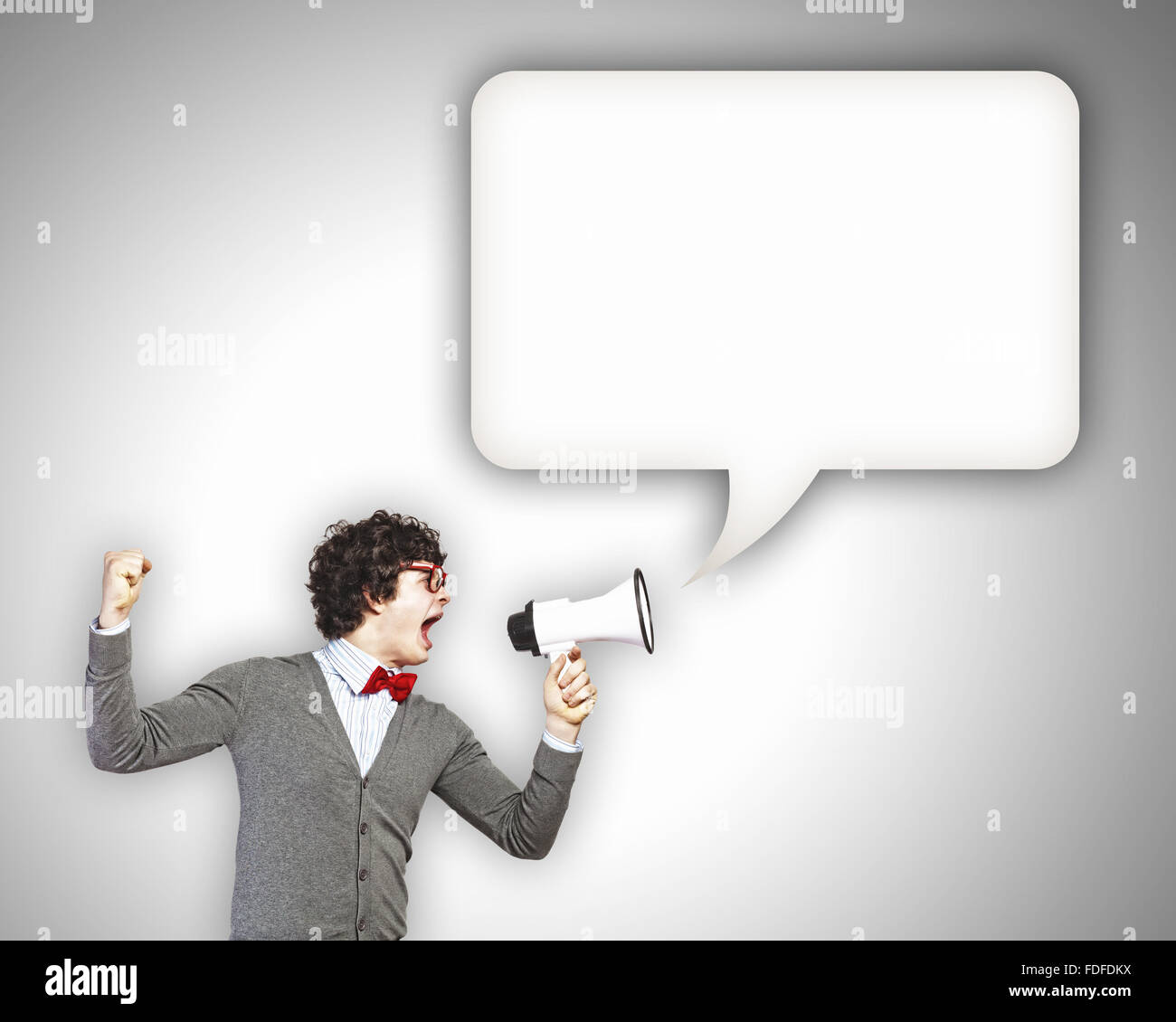 Portrait of young man shouting loudly using megaphone Stock Photo - Alamy