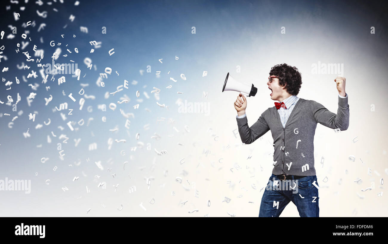 Portrait of young man shouting loudly using megaphone Stock Photo - Alamy
