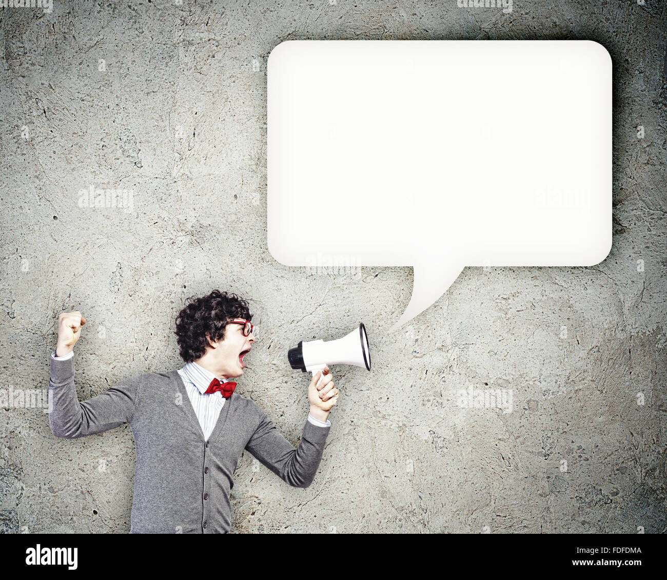 Portrait of young man shouting loudly using megaphone Stock Photo - Alamy