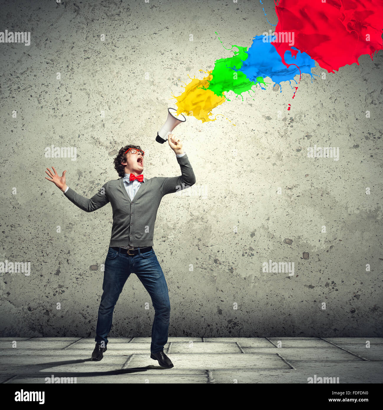 Portrait of young man shouting loudly using megaphone Stock Photo - Alamy