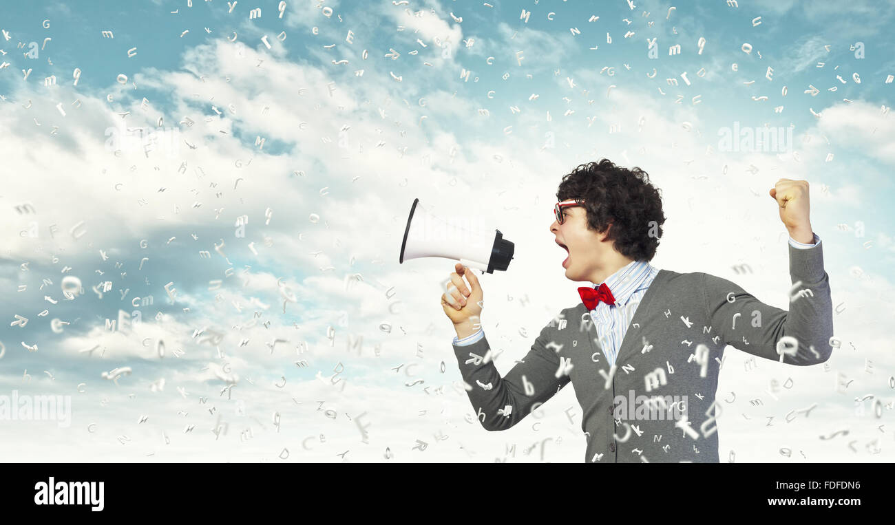 Portrait of young man shouting loudly using megaphone Stock Photo - Alamy