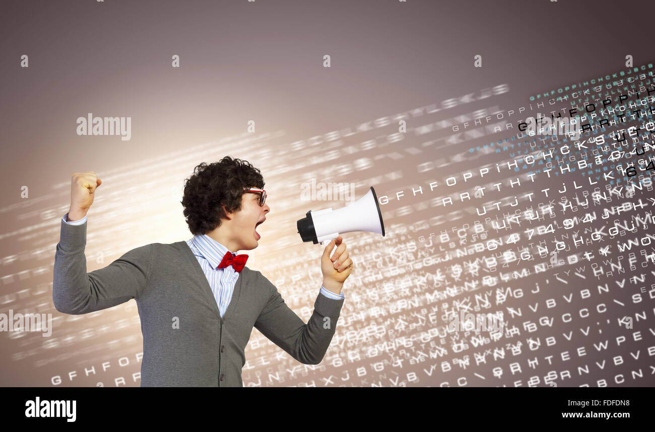 Portrait of young man shouting loudly using megaphone Stock Photo - Alamy