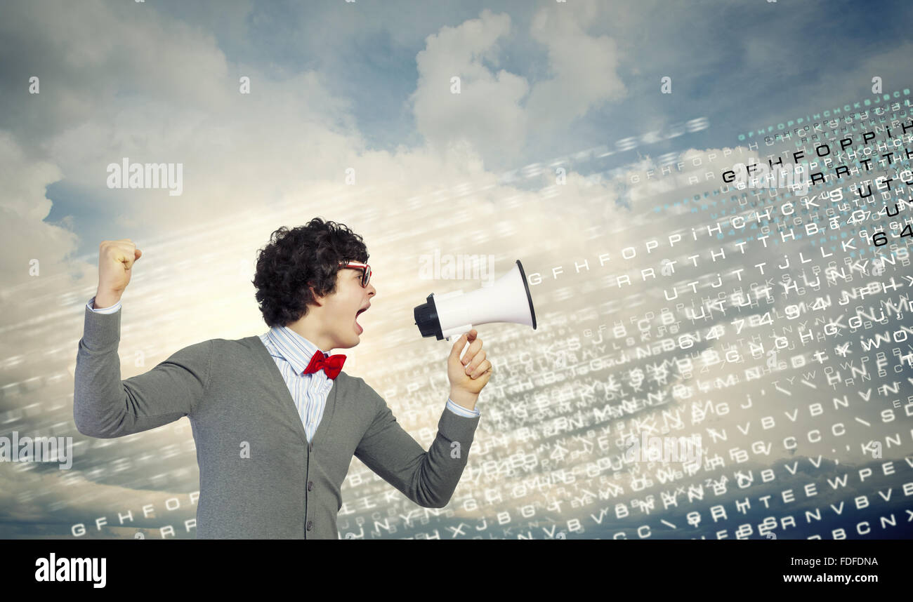 Portrait of young man shouting loudly using megaphone Stock Photo - Alamy