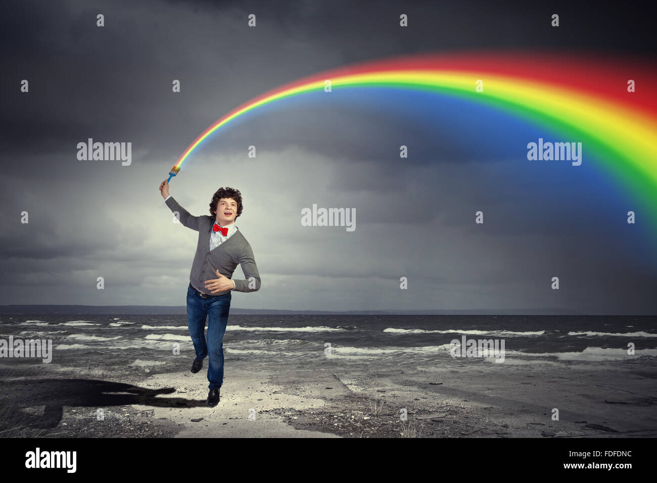 Young man with a splash coloured like a rainbow Stock Photo - Alamy