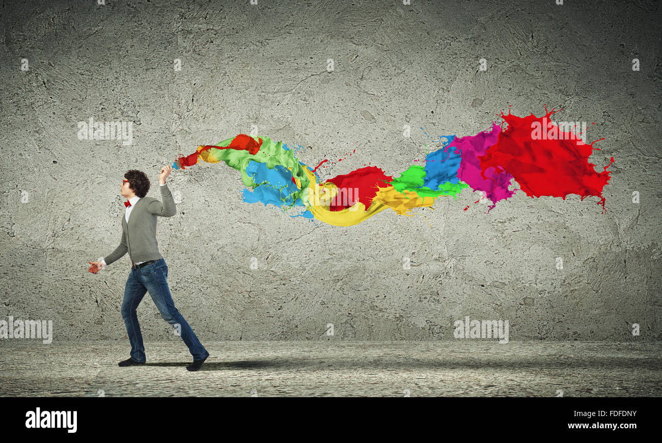 Young man with a splash coloured like a rainbow Stock Photo - Alamy