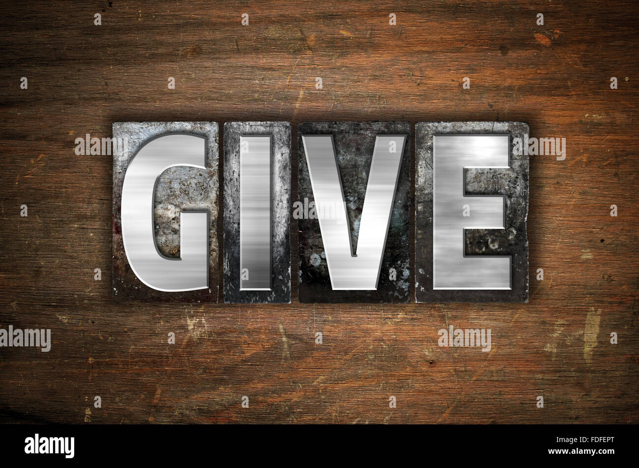 The word "Give" written in vintage metal letterpress type on an aged ...