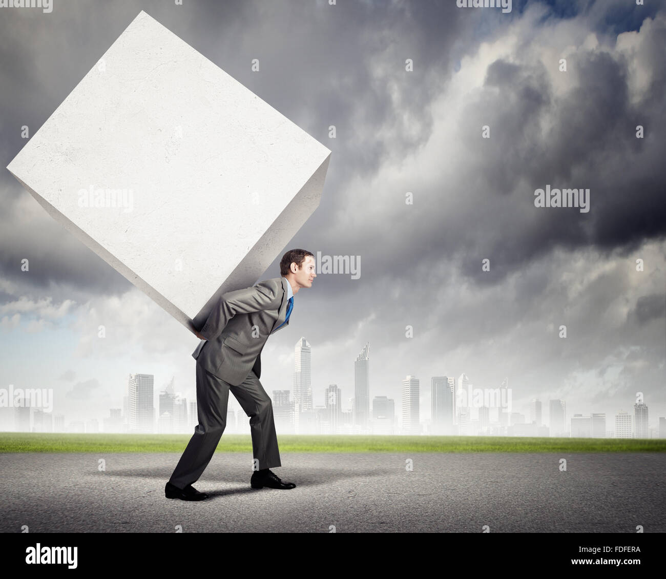 Image of businessman carrying big white cube on his back Stock Photo ...