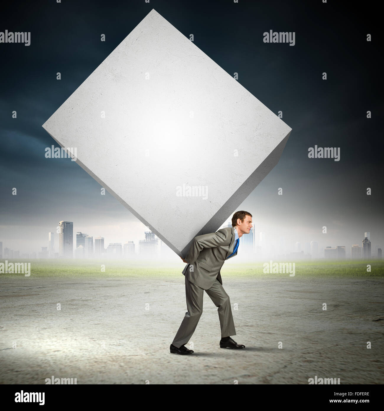 Image of businessman carrying big white cube on his back Stock Photo ...