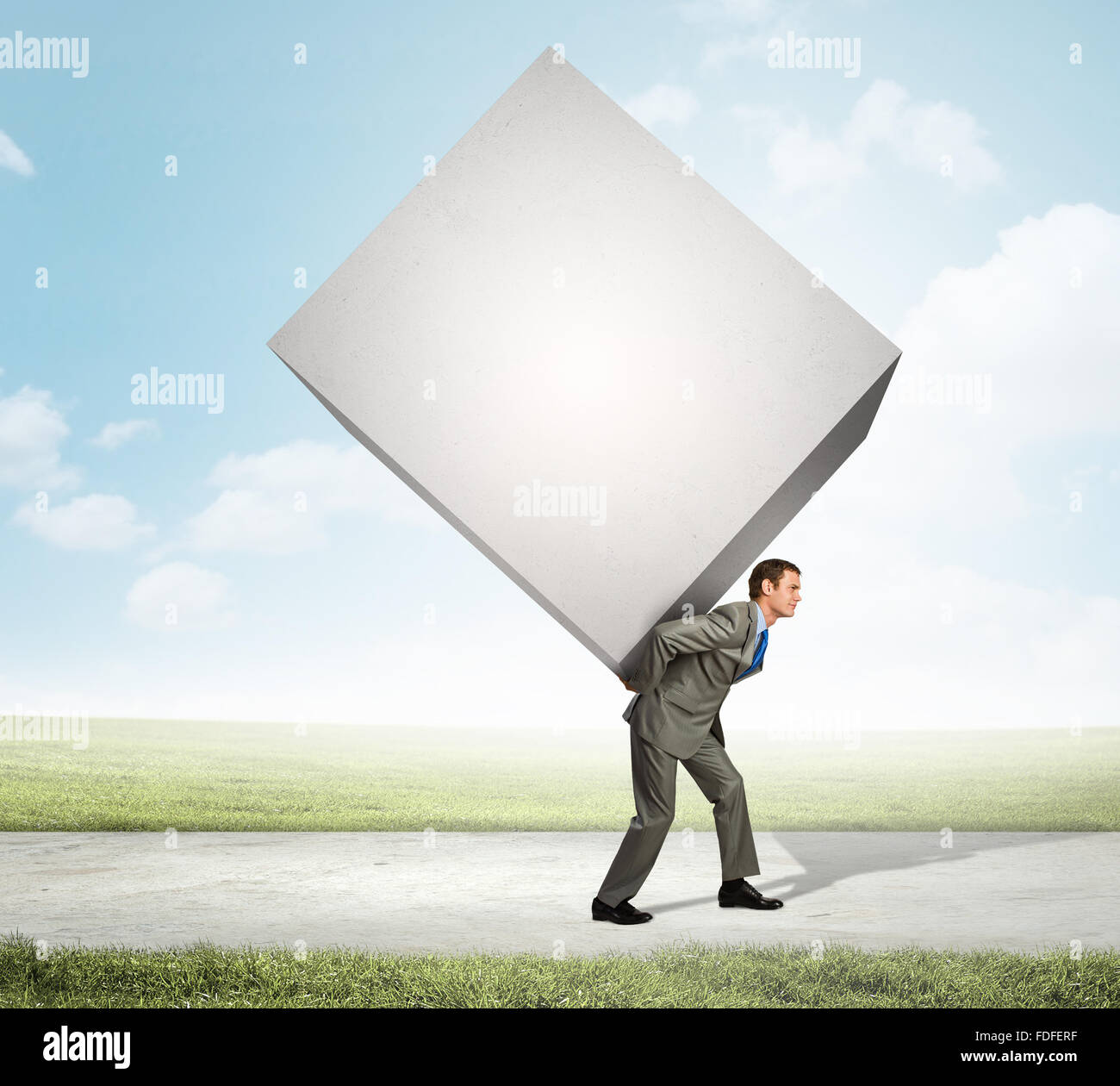 Image of businessman carrying big white cube on his back Stock Photo ...