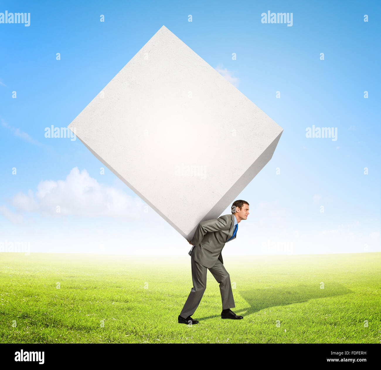 Image of businessman carrying big white cube on his back Stock Photo ...
