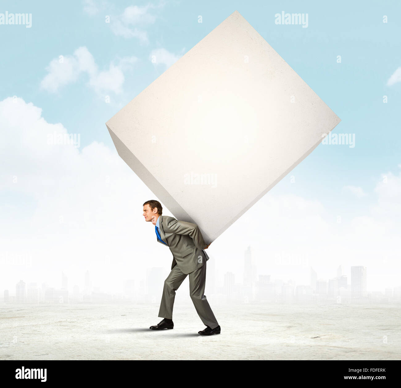 Image of businessman carrying big white cube on his back Stock Photo ...