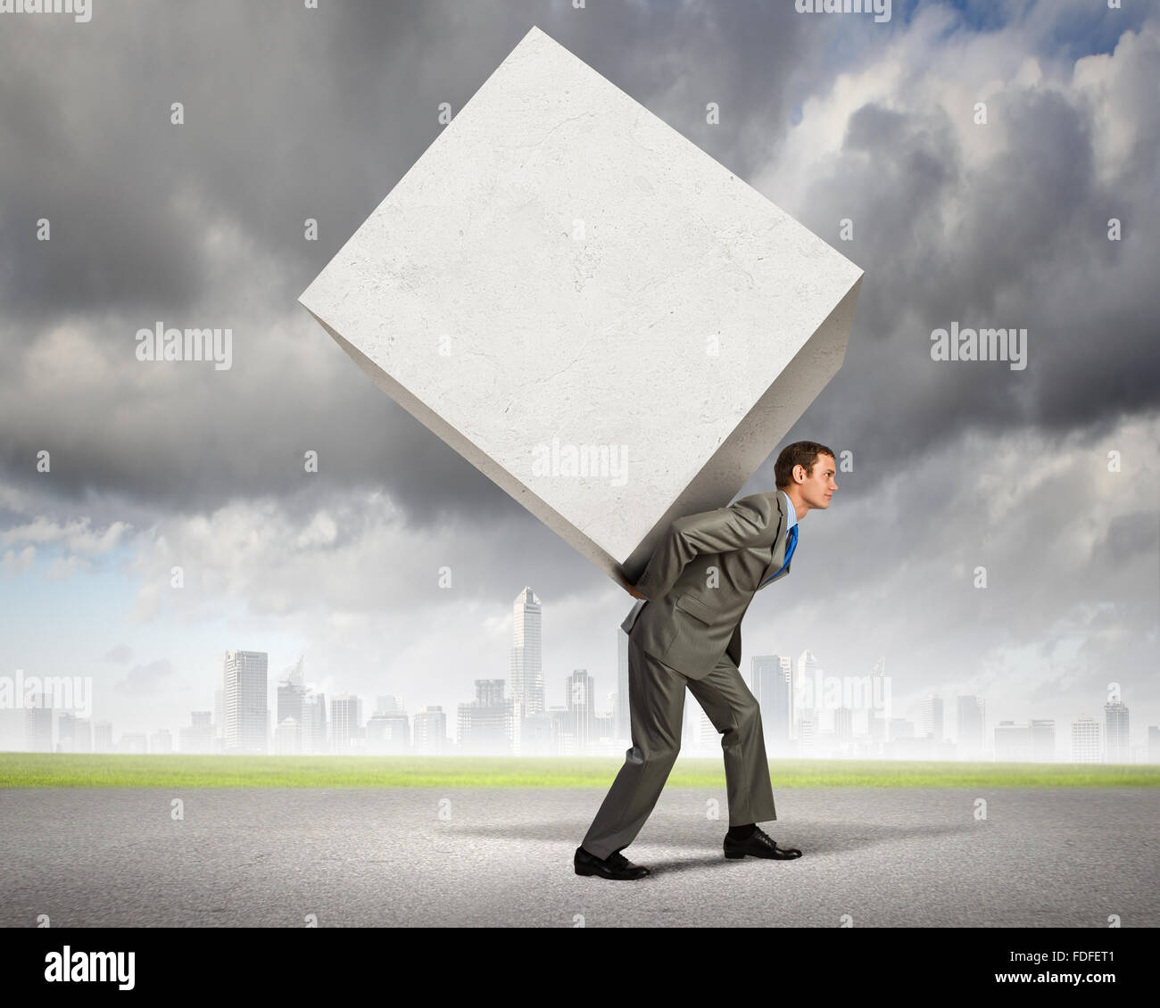 Image of businessman carrying big white cube on his back Stock Photo ...