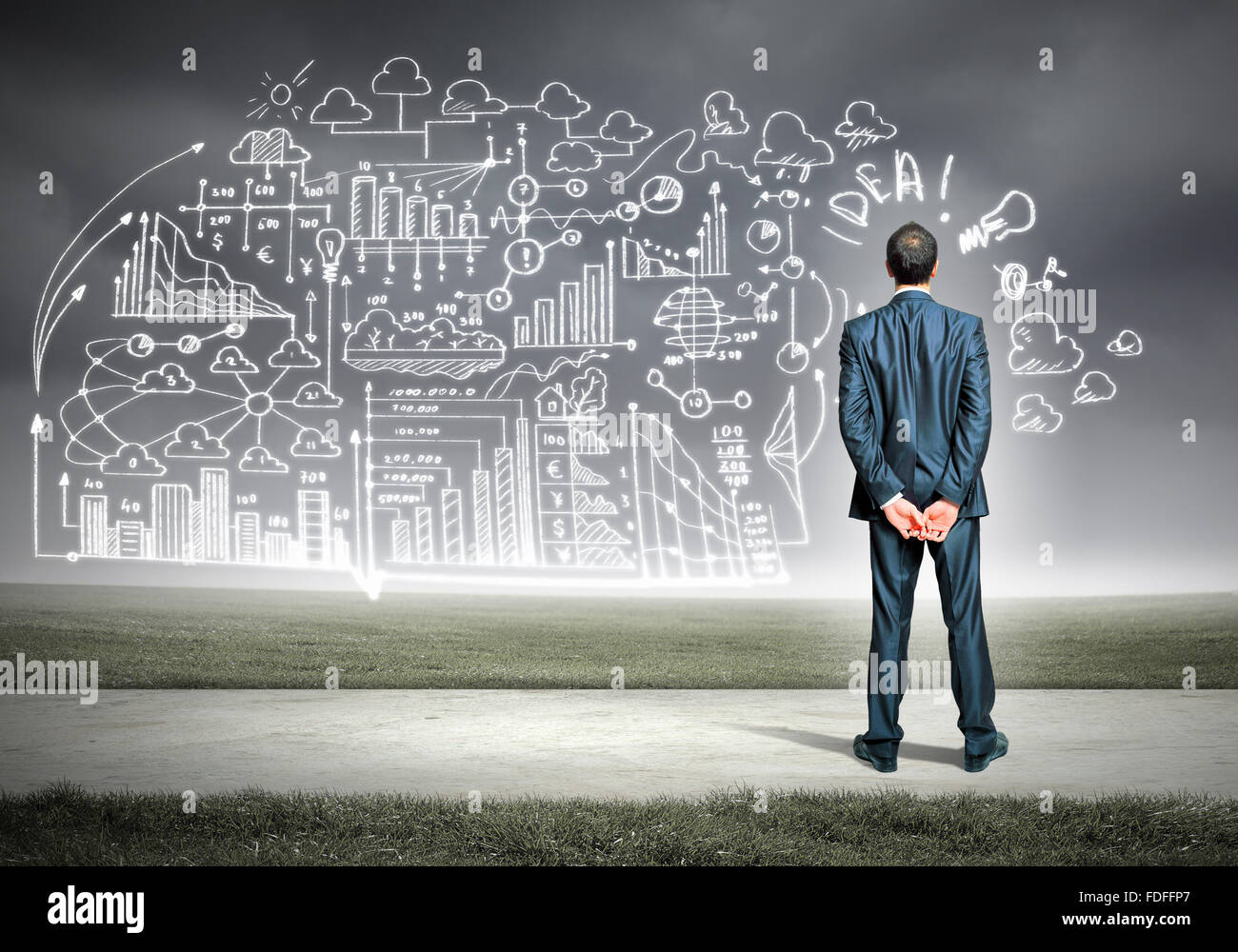 Back view image of young businessman standing against business sketch ...
