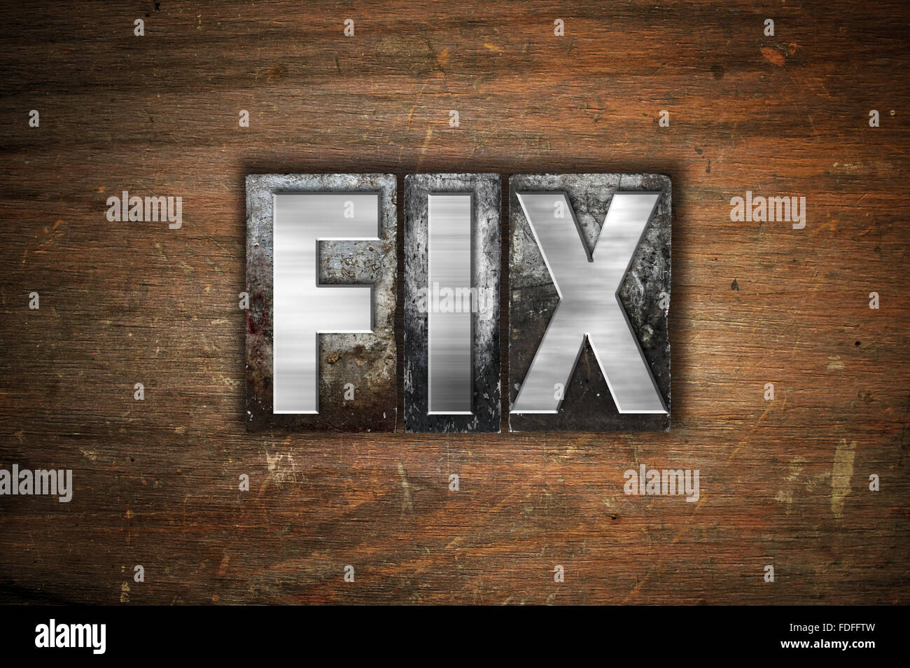 The word "Fix" written in vintage metal letterpress type on an aged ...