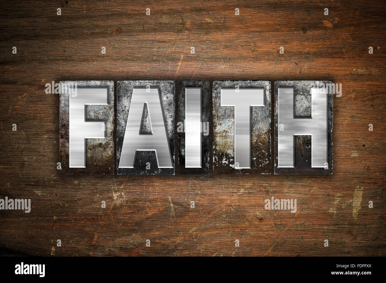 The word "Faith" written in vintage metal letterpress type on an aged ...