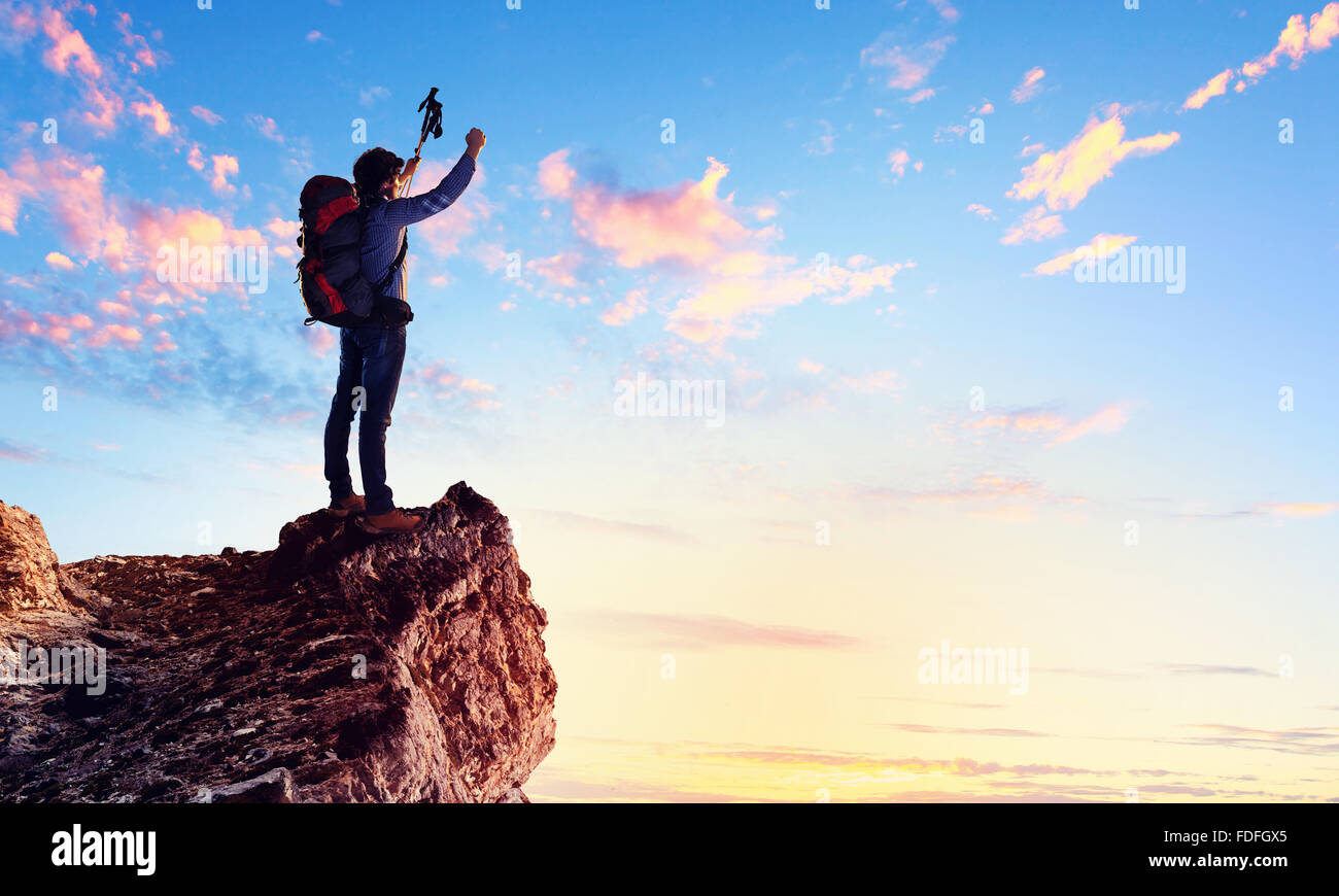 Image of young man mountaineer standing atop of rock Stock Photo - Alamy