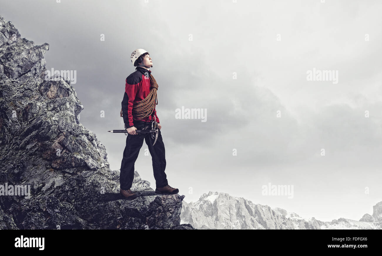 Image of young man mountaineer standing atop of rock Stock Photo - Alamy