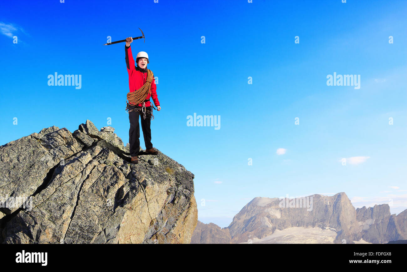 Image of young man mountaineer standing atop of rock Stock Photo - Alamy