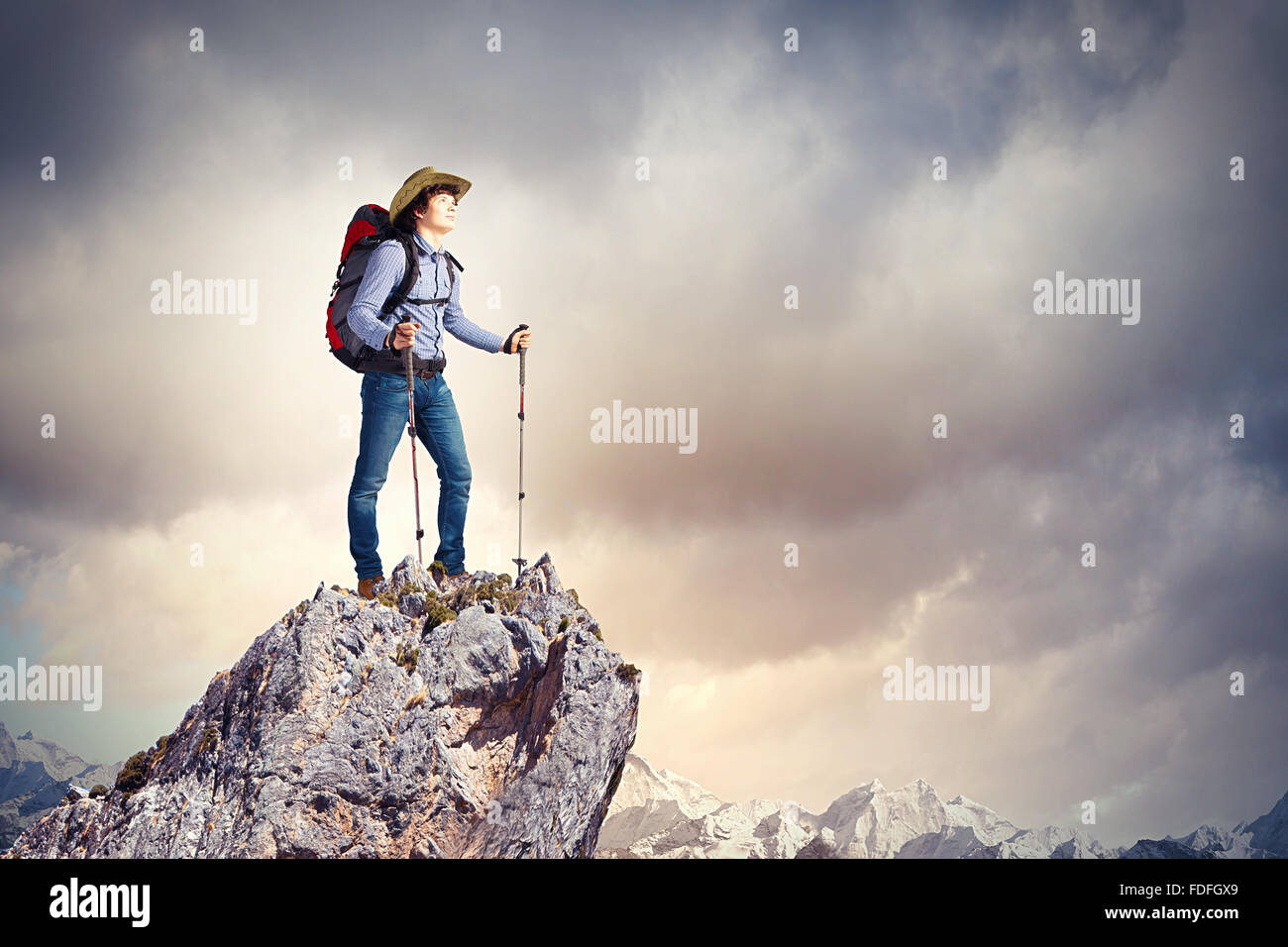 Image of young man mountaineer standing atop of rock Stock Photo - Alamy