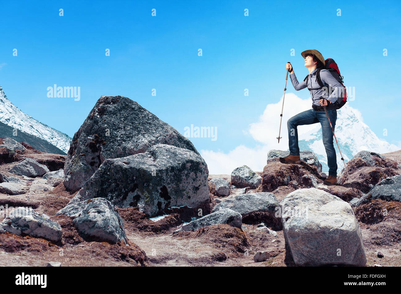 Image of young man mountaineer standing atop of rock Stock Photo - Alamy