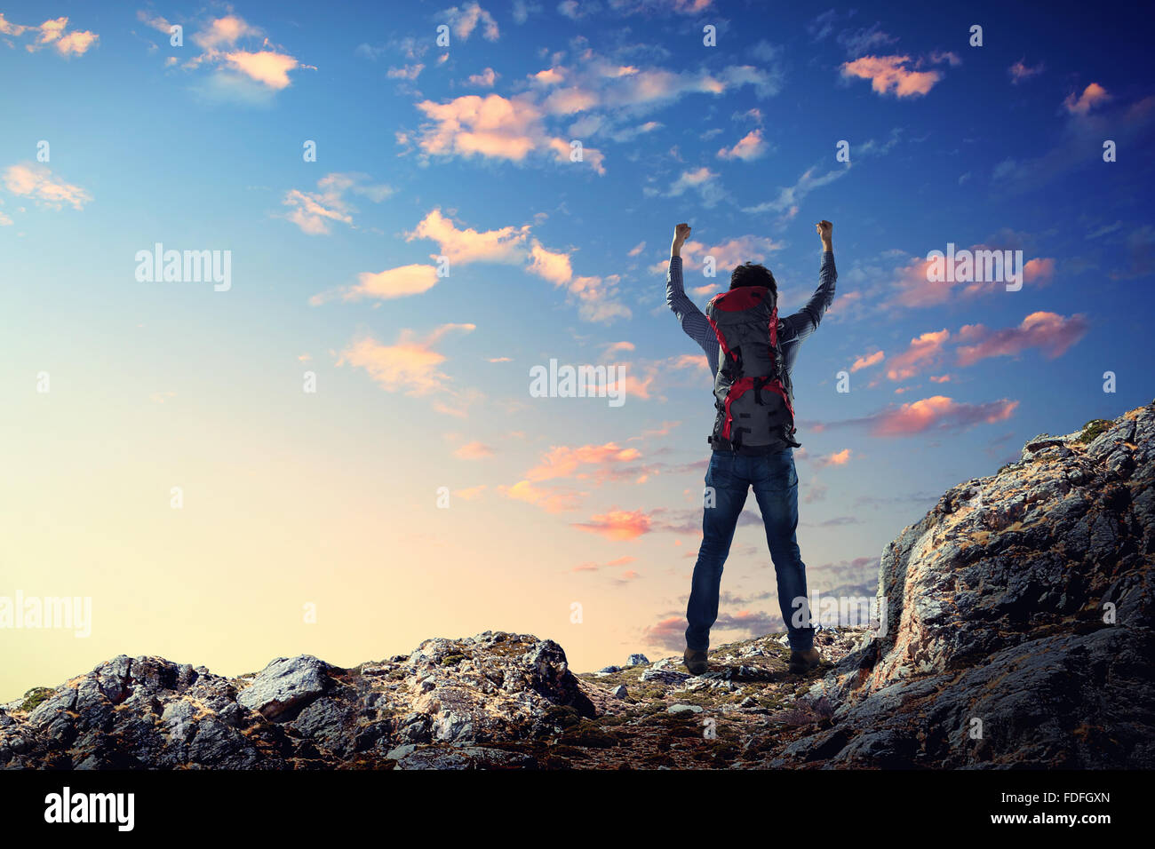 Image of young man mountaineer standing atop of rock Stock Photo - Alamy