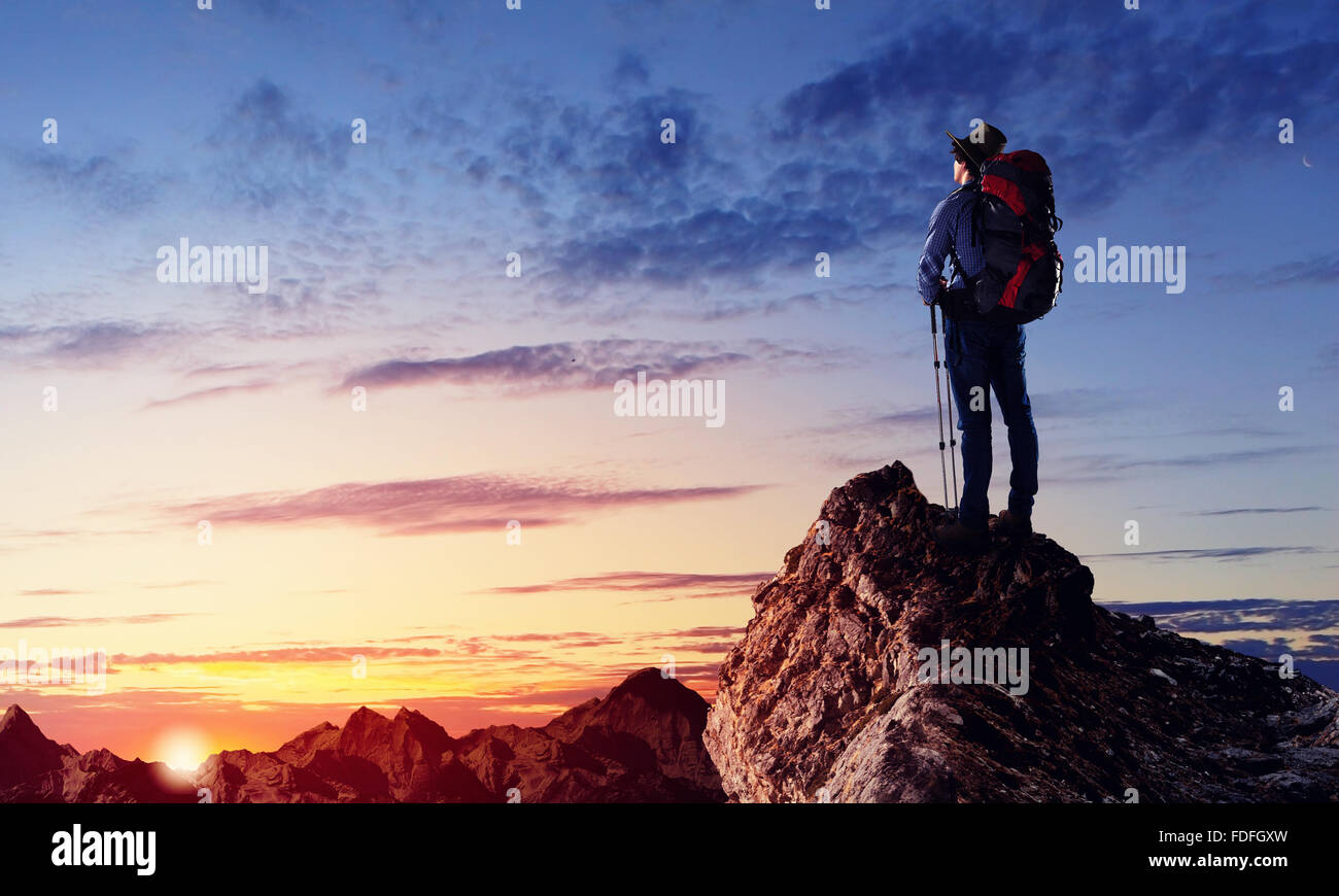 Image of young man mountaineer standing atop of rock Stock Photo - Alamy