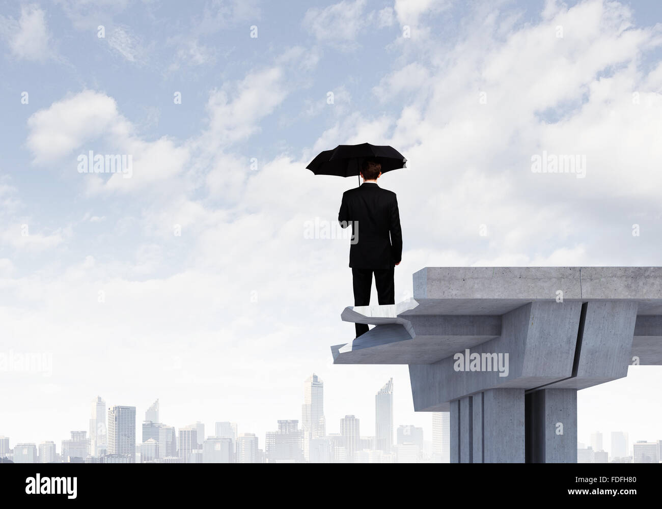 Image of businessman with umbrella standing at the edge of bridge Stock ...