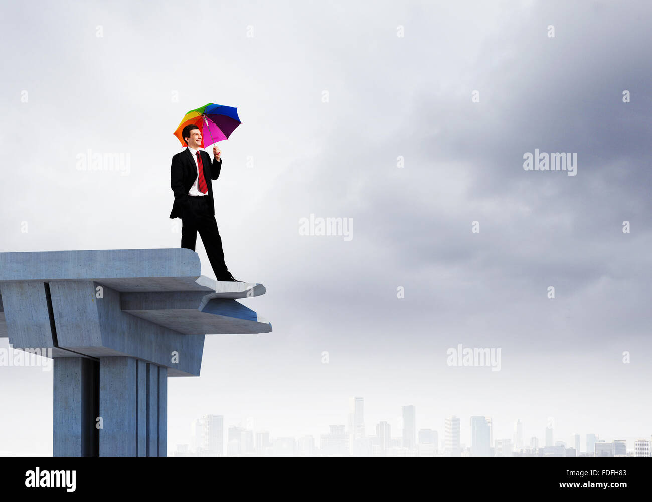 Image of businessman with umbrella standing at the edge of bridge Stock ...